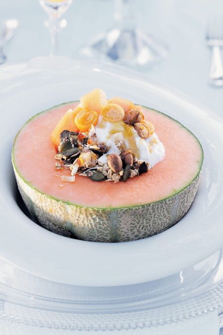 Toasted wheat-free muesli served in a melon with Greek-style yoghurt ...